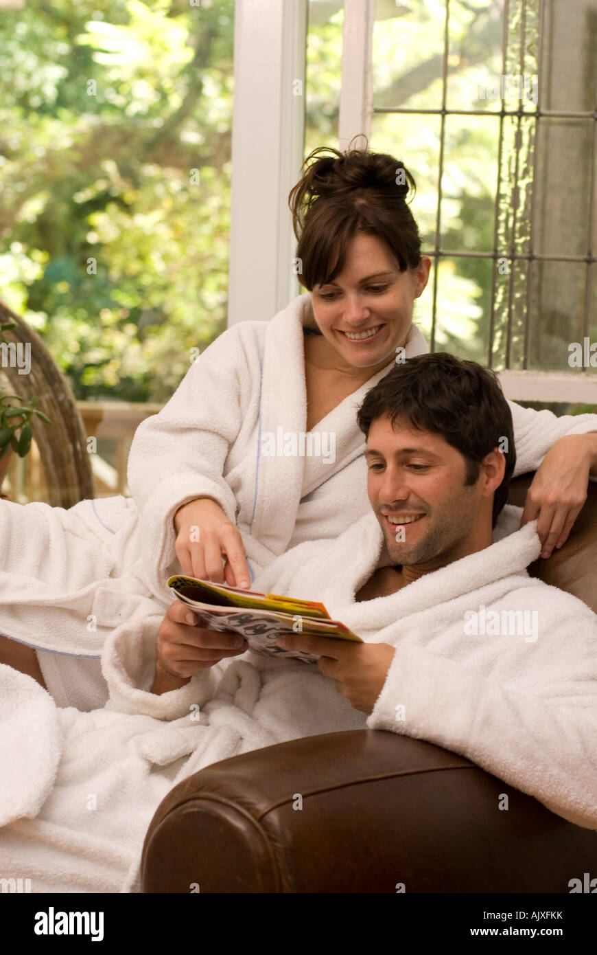 young couple reading newspaper Stock Photo - Alamy