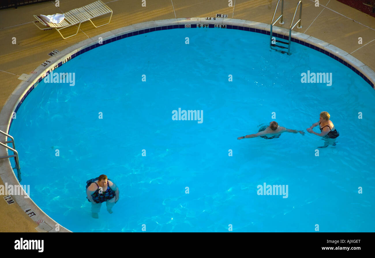 Three people in a swimming pool Stock Photo - Alamy