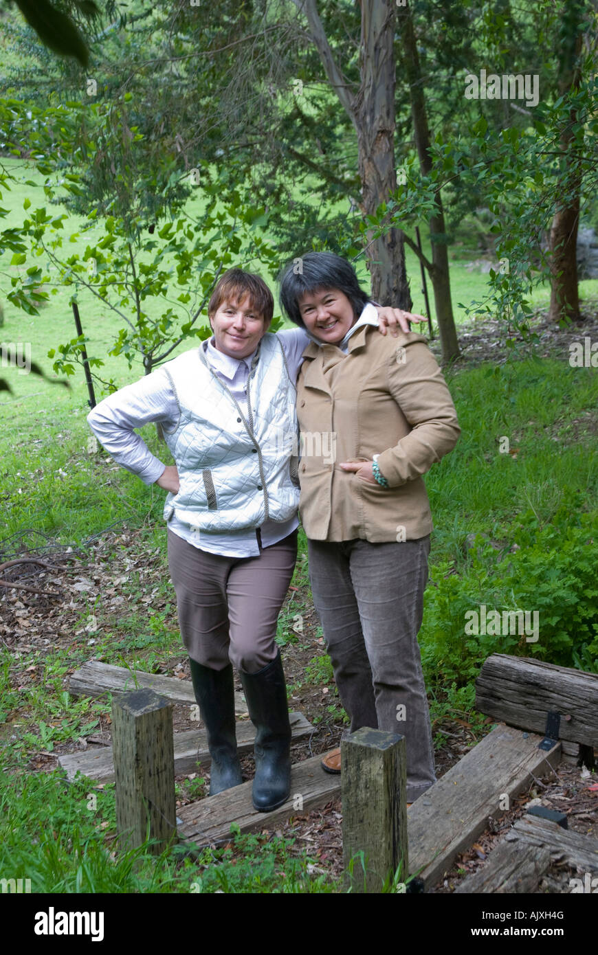 Two mature woman in a country setting smiling to camera Stock Photo - Alamy