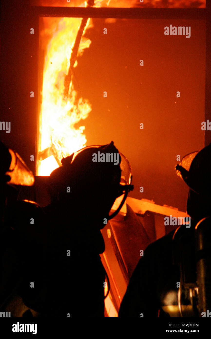 Fire fighters in a room of fire Stock Photo - Alamy