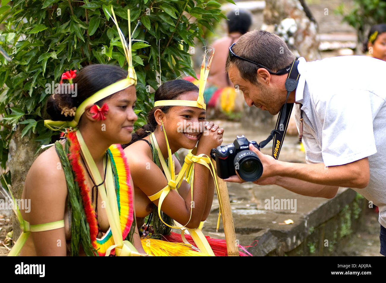 A digital photographer shows two Yapese girls his photographs Yap ...