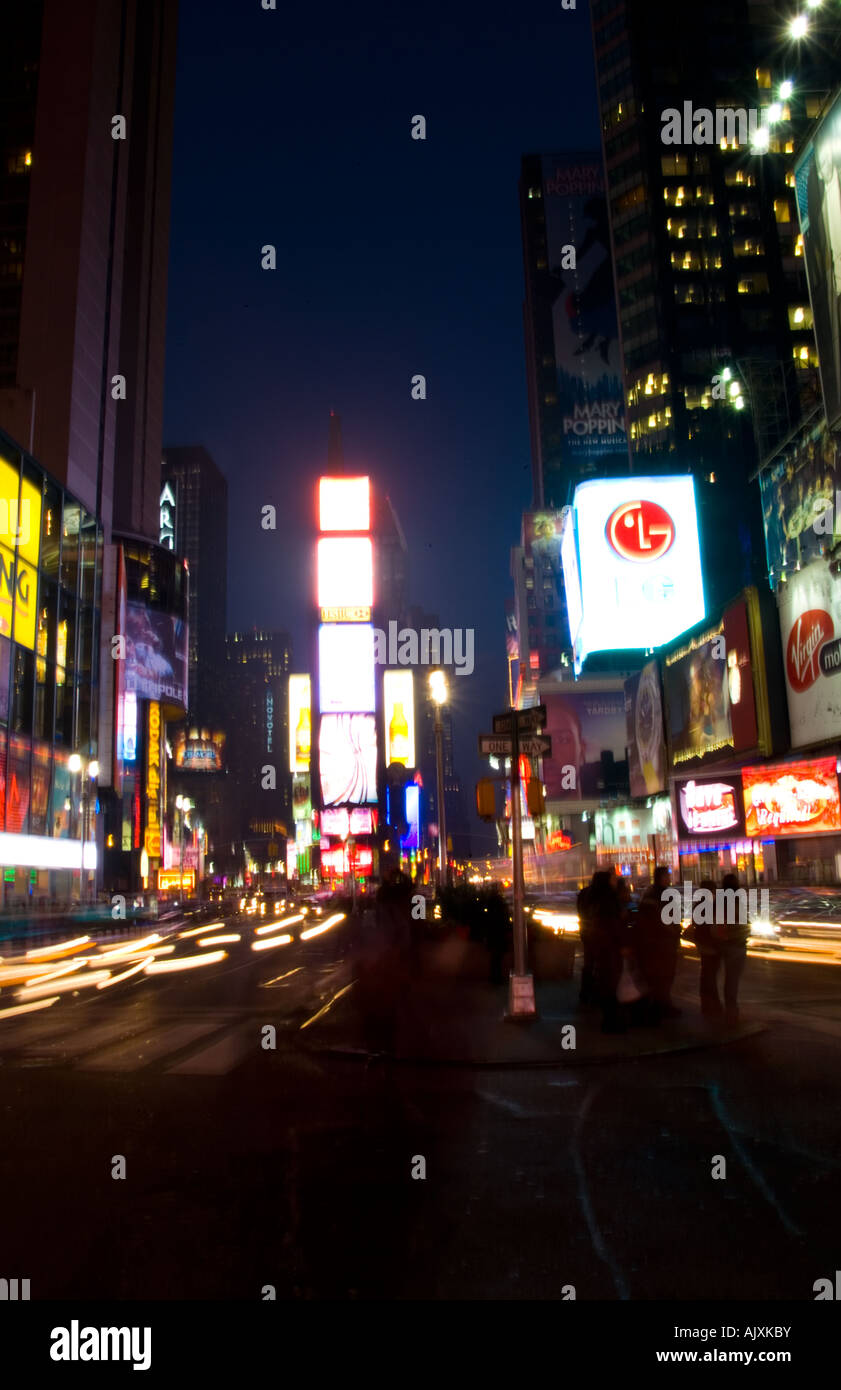 World famous Times Square at night with excitement florescent signs and ...
