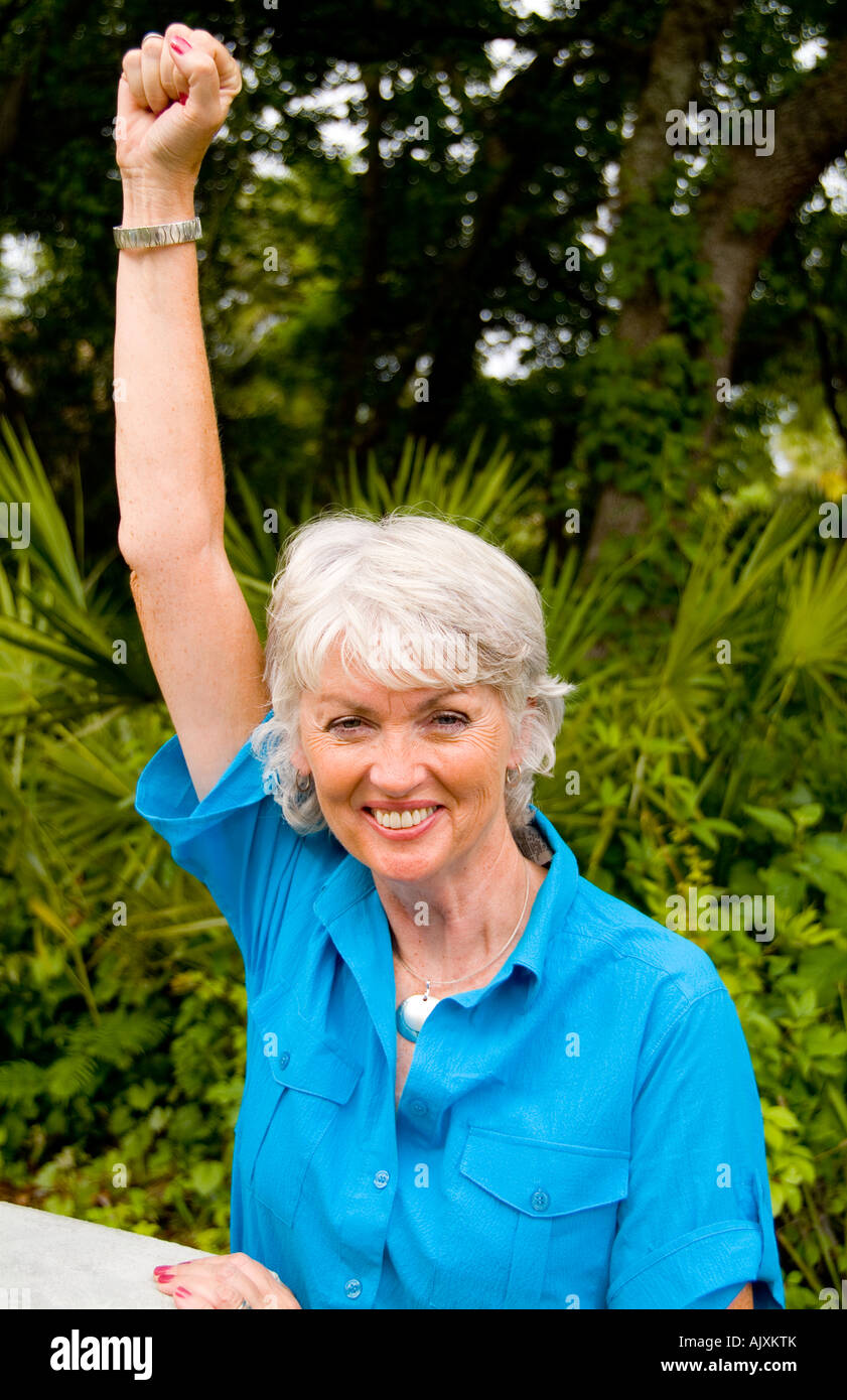 Attractive colorful woman in her 60s smiling outdoors and happy Stock ...
