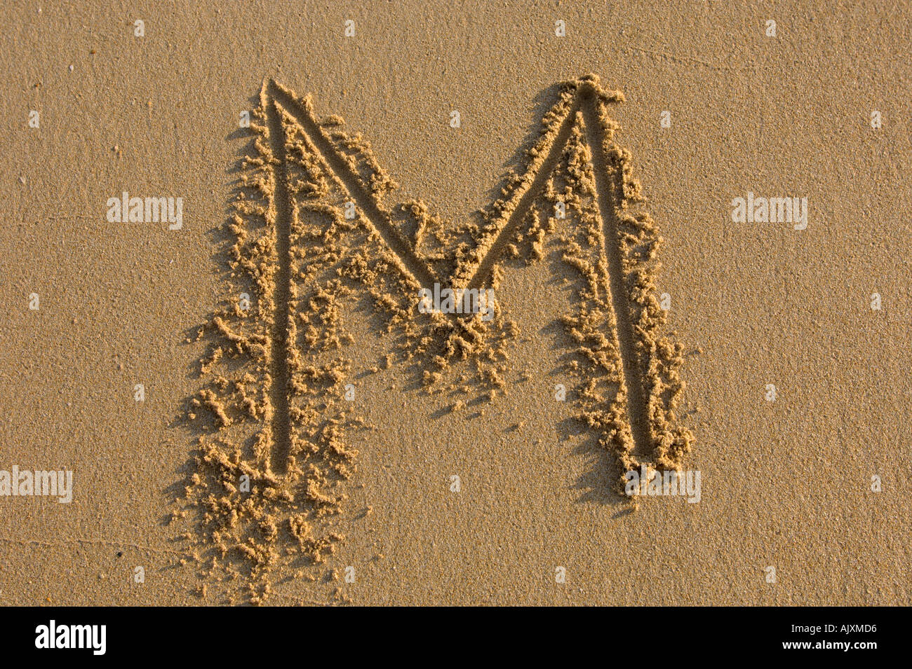 Alphabet hand writen letters on the sand Stock Photo - Alamy
