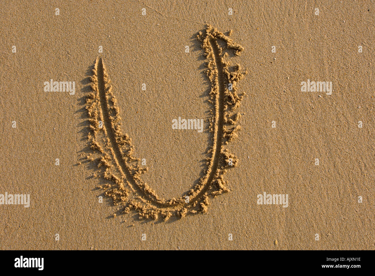 Alphabet hand writen letters on the sand Stock Photo - Alamy
