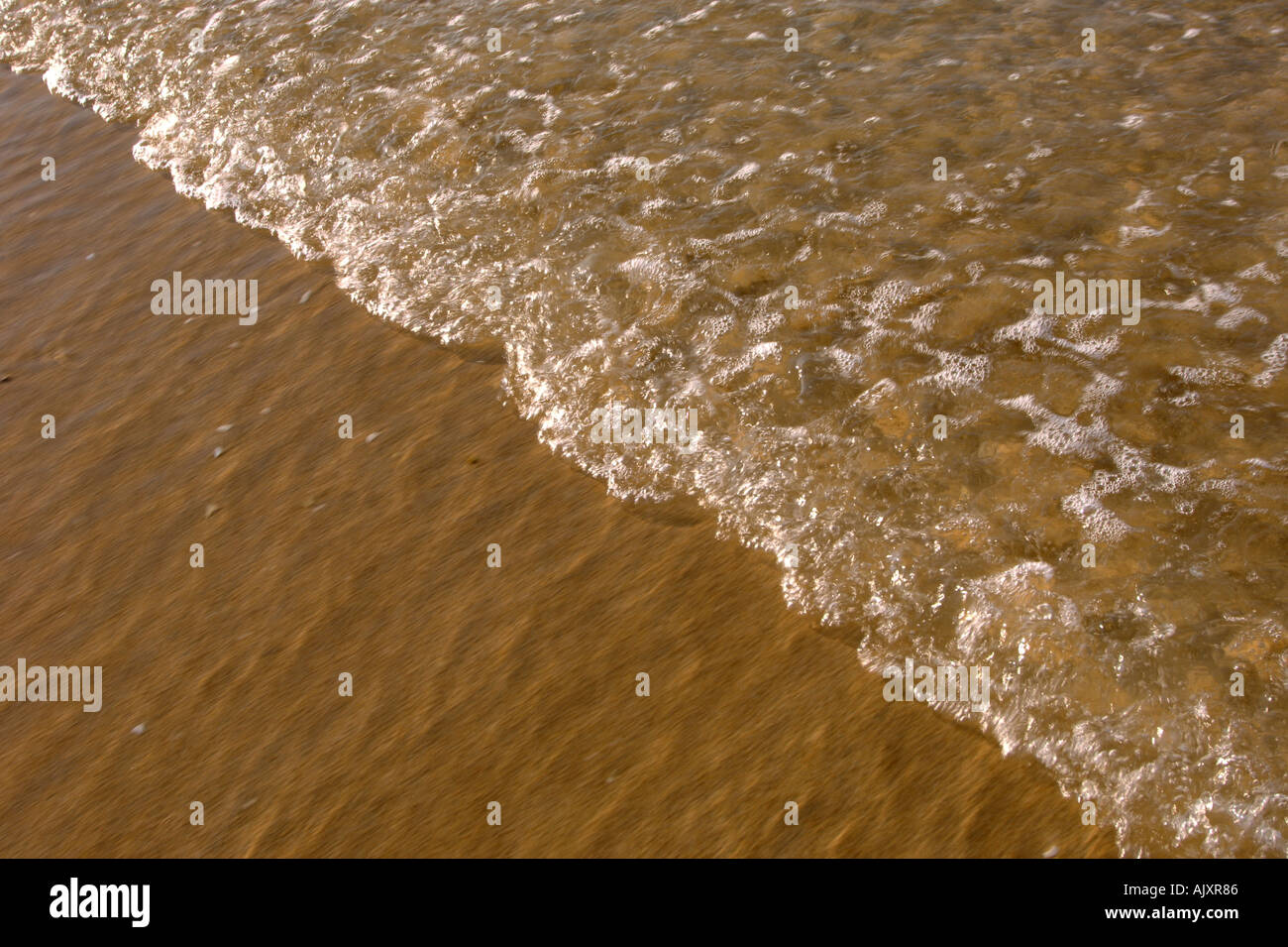 small wave on the beach Stock Photo - Alamy