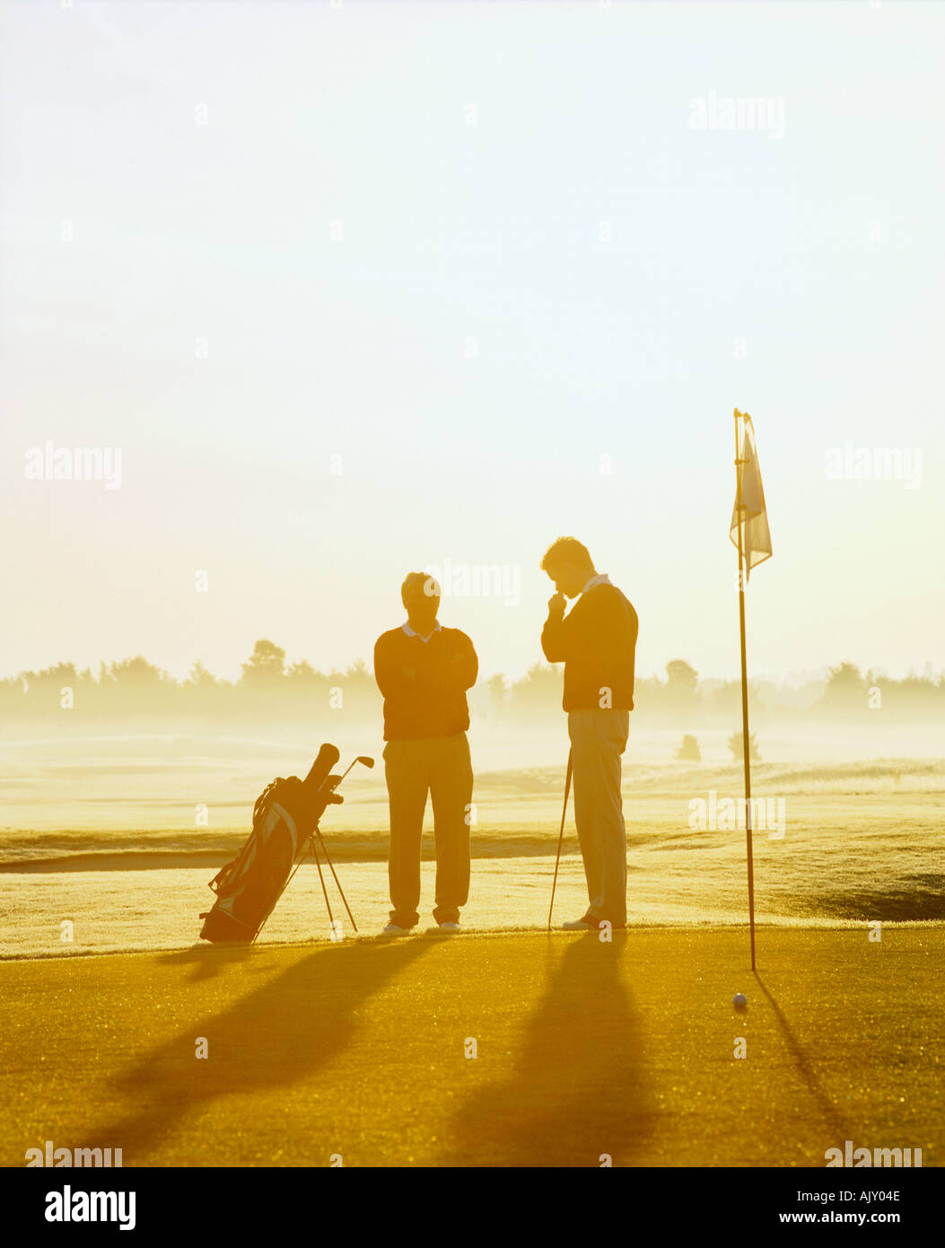 Evening golfers with sun setting hi-res stock photography and images ...