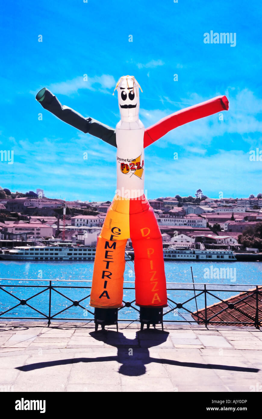 Amusing inflated figure with his back to the River Douro in Oporto ...