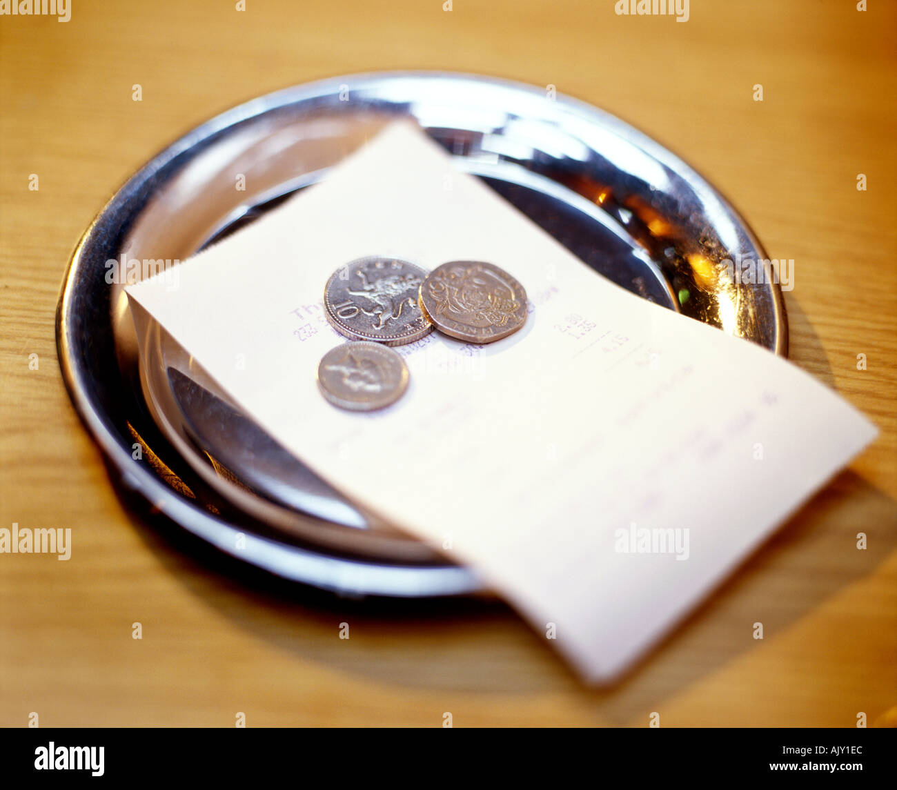 tip tray with till receipt and change Stock Photo - Alamy