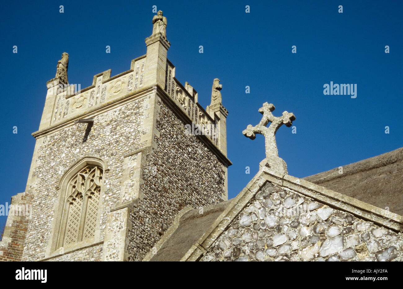 Church tower and entrance porch with crucifix Beighton Norfolk UK Stock ...