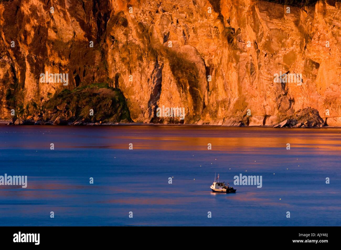 Cliffs of Cap-Bon-Ami and crab boat at dawn, Forillon National Park, QC ...