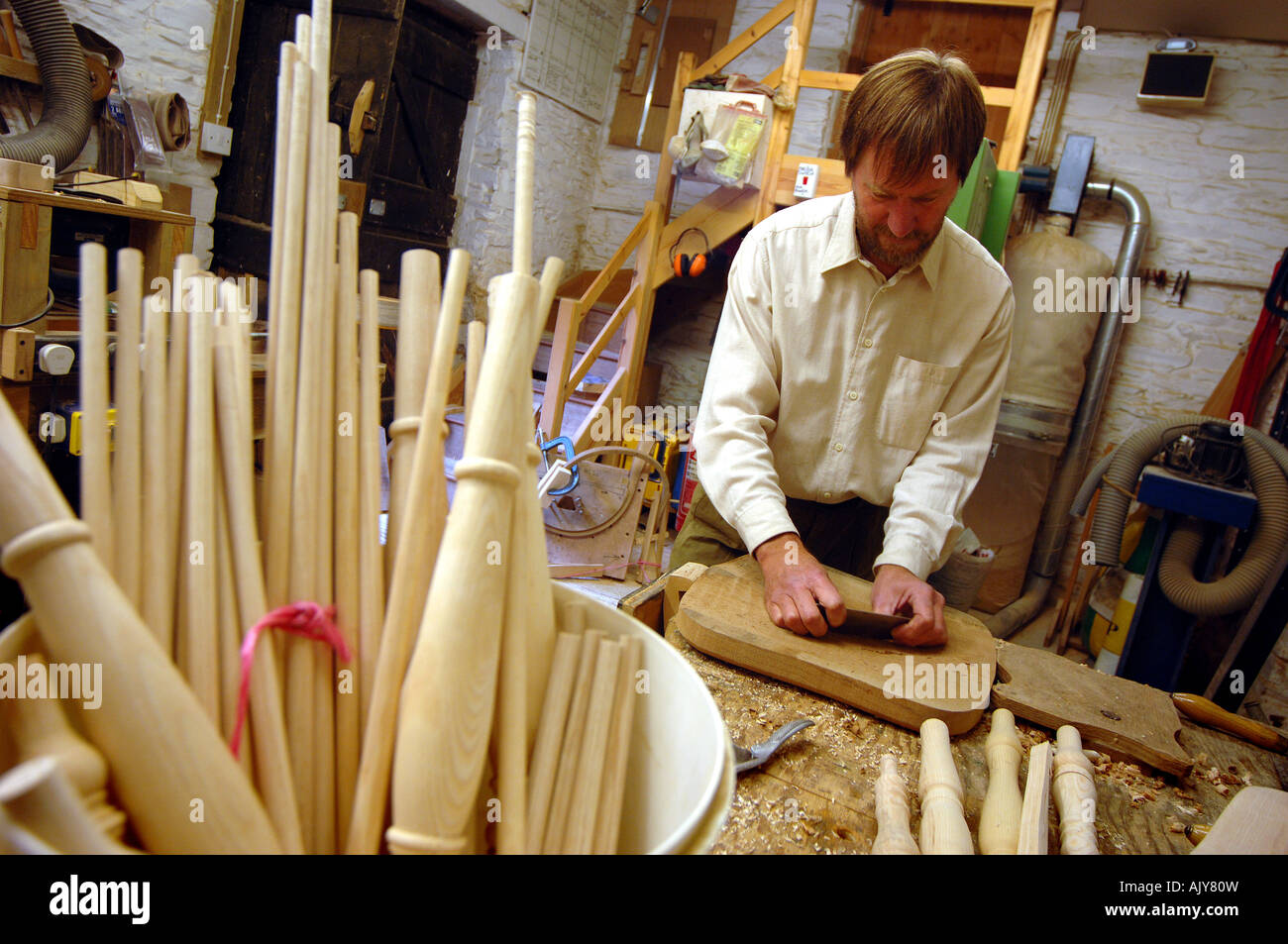 A male woodworker in his workshop, surrounded by chair legs Stock Photo ...