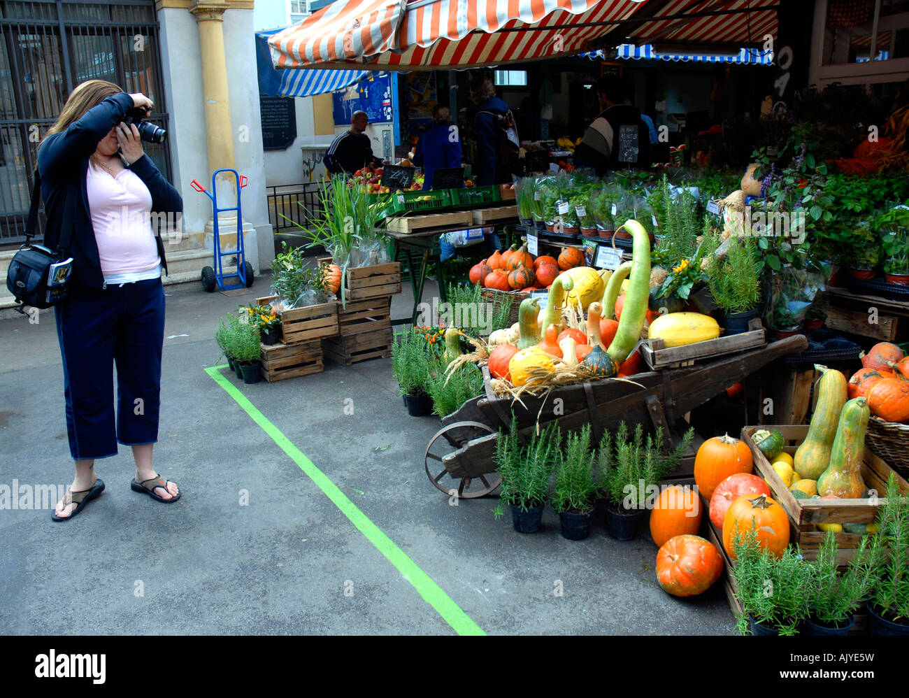 Tourist taking pictures Naschmarkt market stall Vienna Austria Stock ...