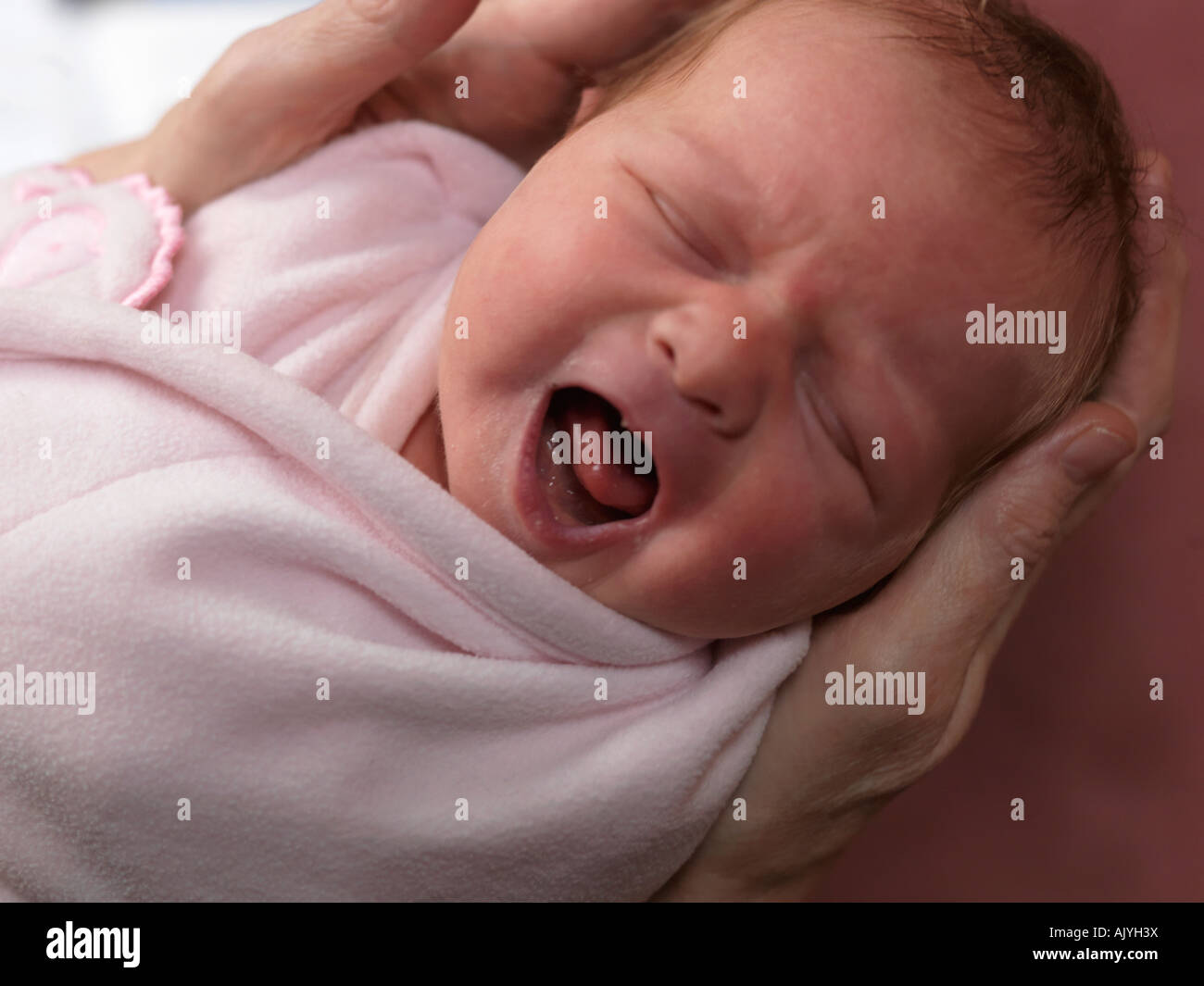 Swaddled baby crying hi-res stock photography and images - Alamy