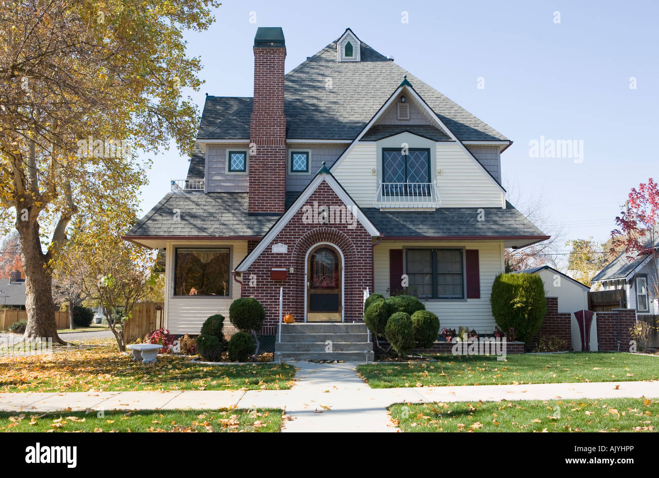 Cute vintage brick and cream colored house in the fall Stock Photo - Alamy