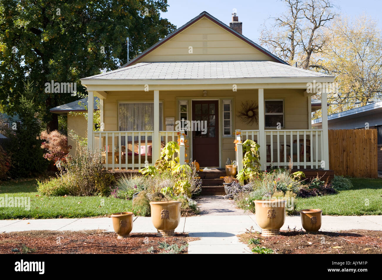 Cute yellow vintage house in the fall Stock Photo - Alamy