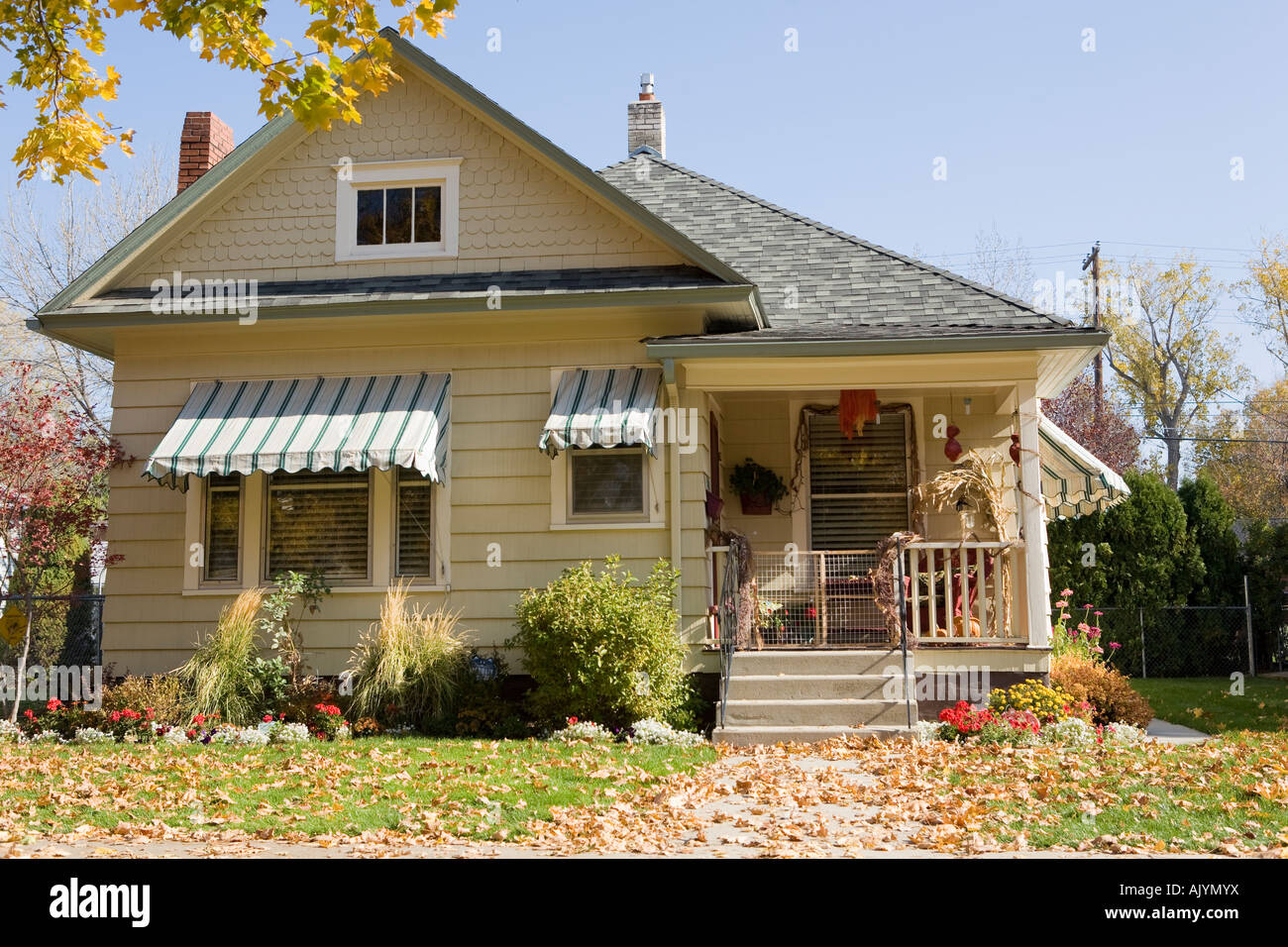Cute yellow vintage house in the fall Stock Photo - Alamy