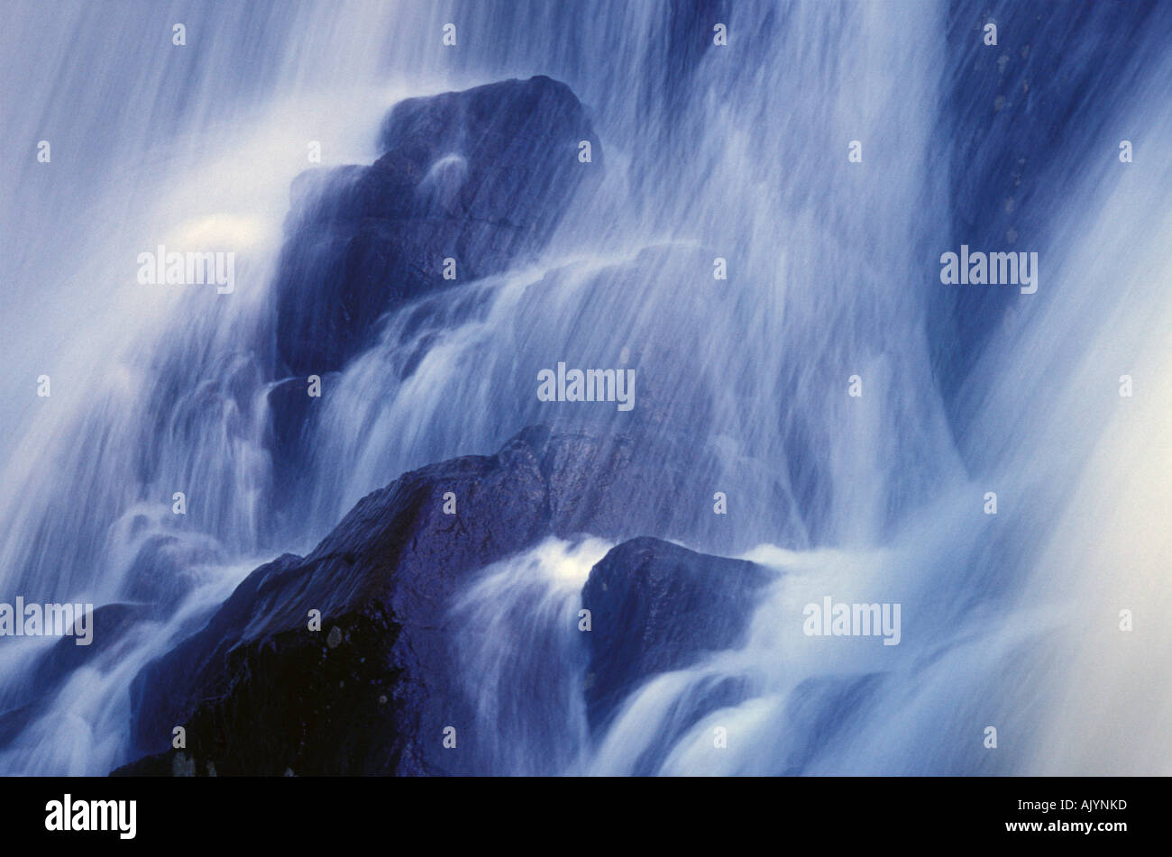 Water crashing over rocks at the base of a waterfall in Quebec Stock ...