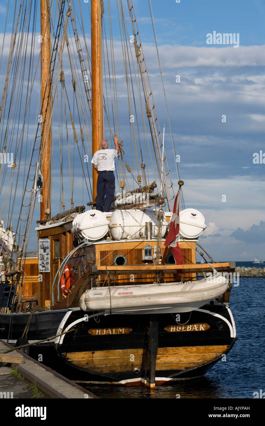 Sailor adjusting sails of a beautiful old style wooden sailboat Stock ...