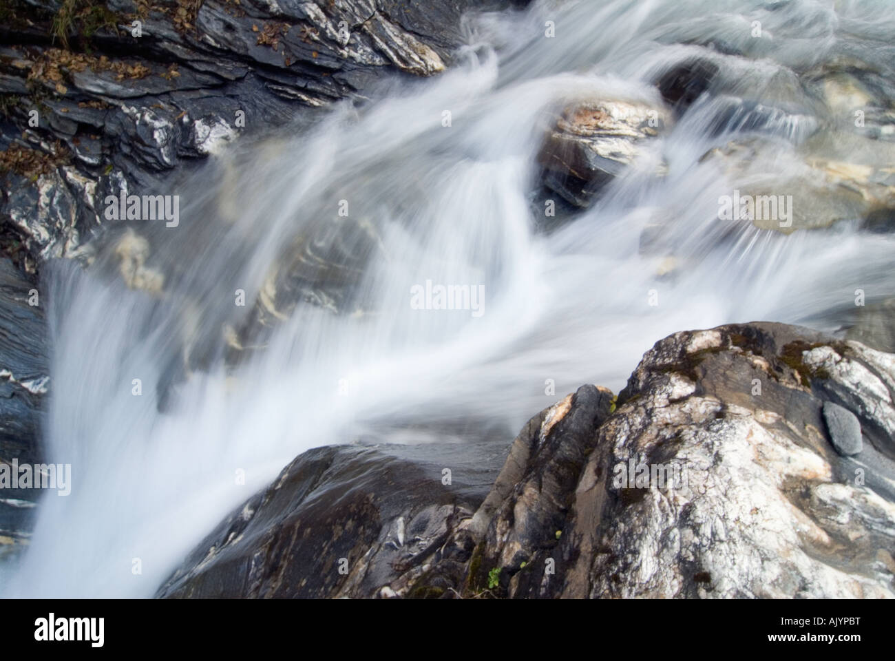 Floating water in a brook in the swiss alps Stock Photo - Alamy