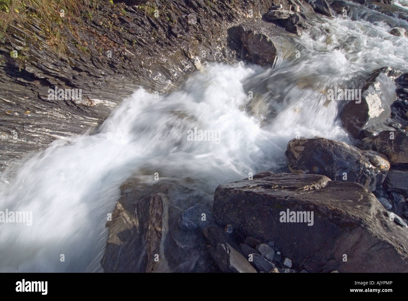 Floating water in a brook in the swiss alps Stock Photo - Alamy