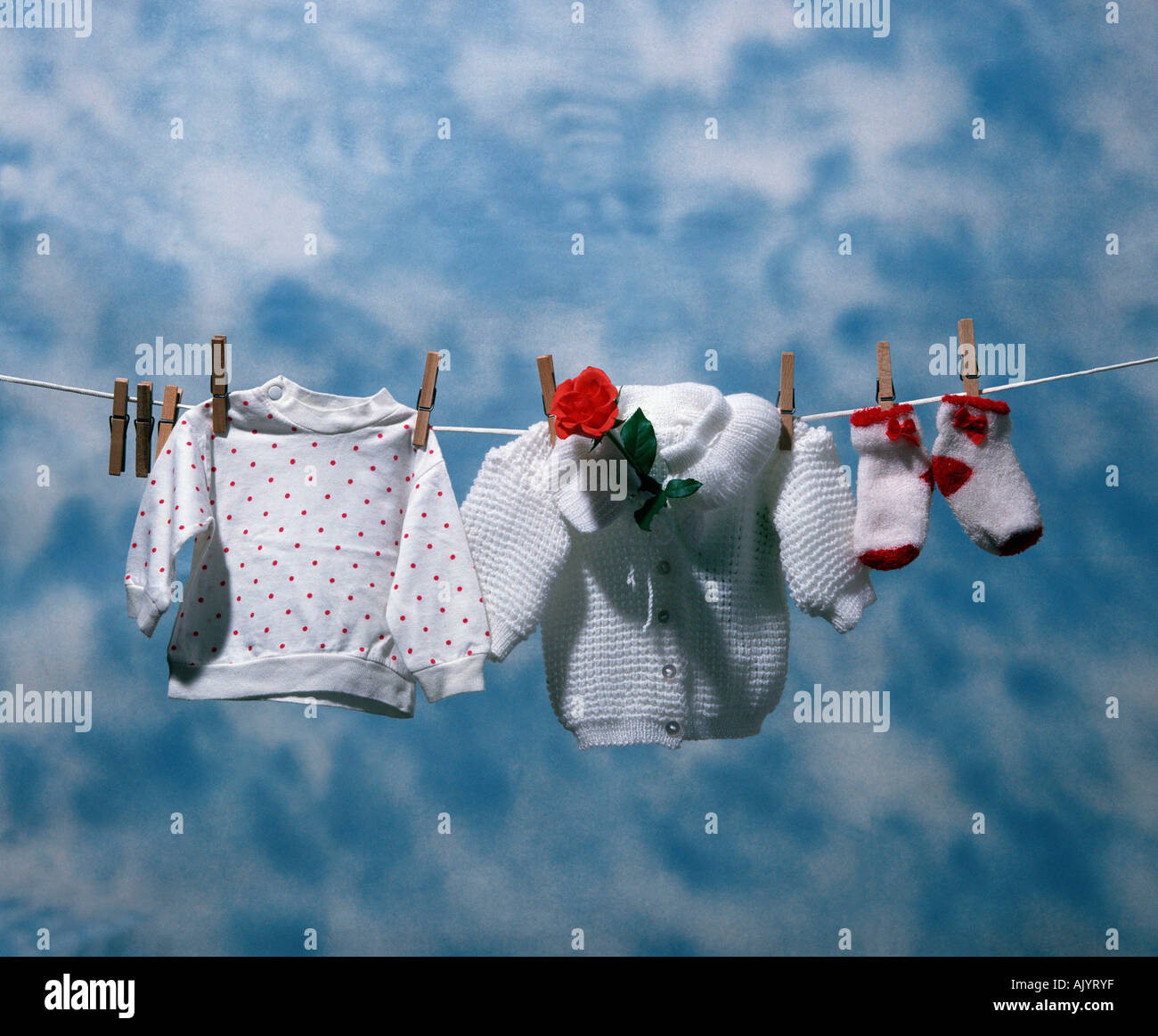 Baby's clothes on clothes line Stock Photo - Alamy