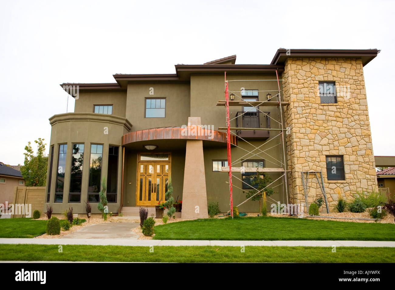 Large modern home with stone on front Stock Photo - Alamy