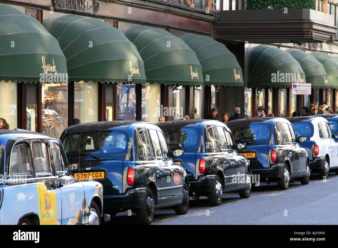 row of black cabs taxis outside harrods department store knightsbridge ...