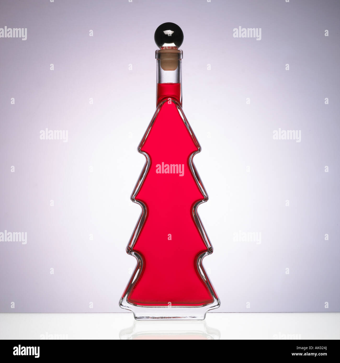 GLASS BOTTLE IN SHAPE OF CHRISTMAS TREE FULL OF RED LIQUID Stock Photo ...