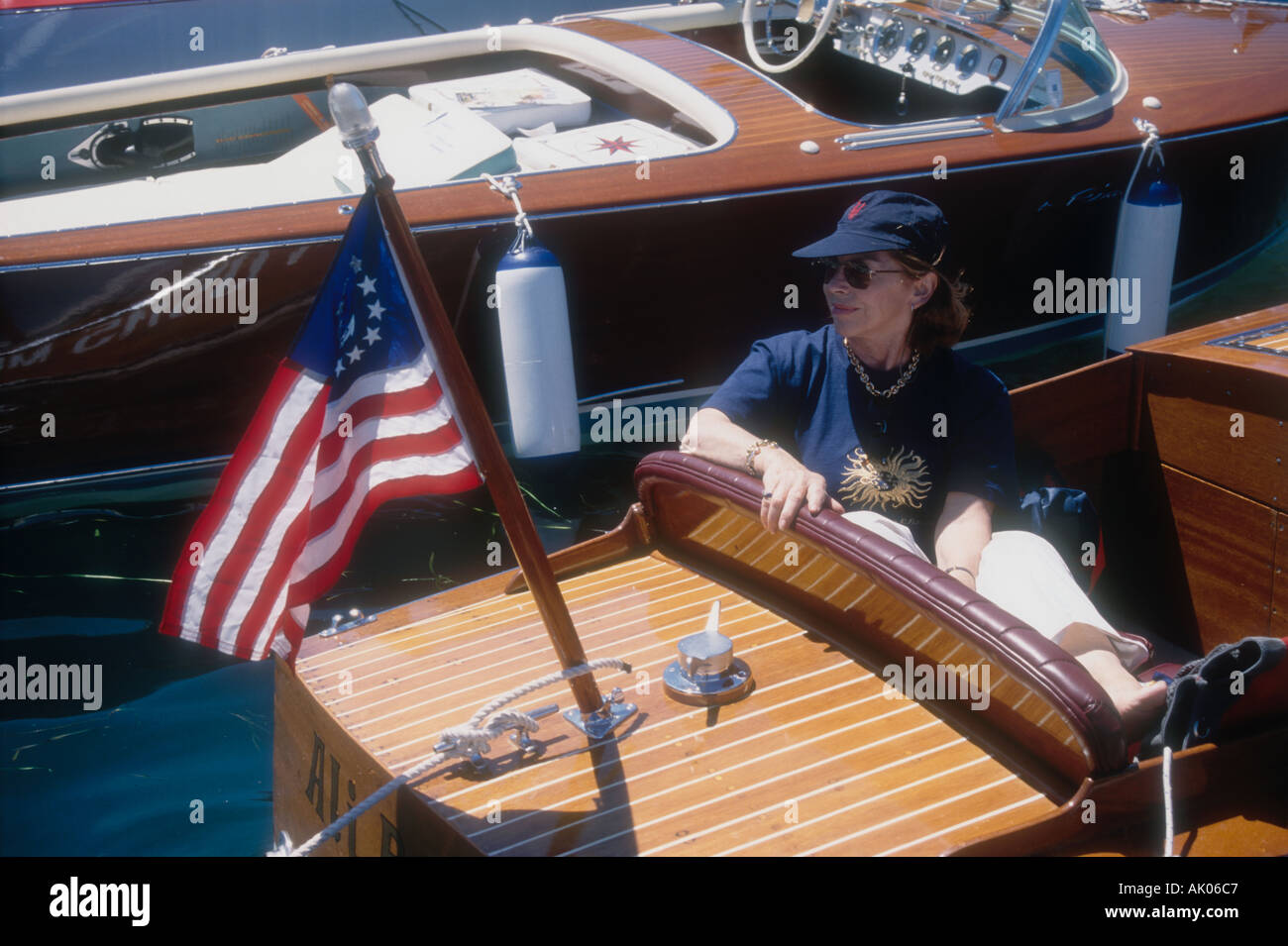 A lady in an American Chris Craft runabout motorboat at Lake Garda ...
