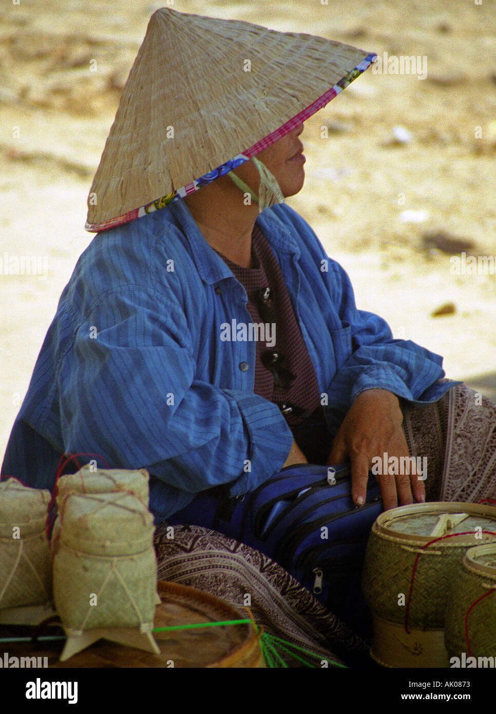 Indigenous woman with traditional conical straw hat sit sell handmade ...