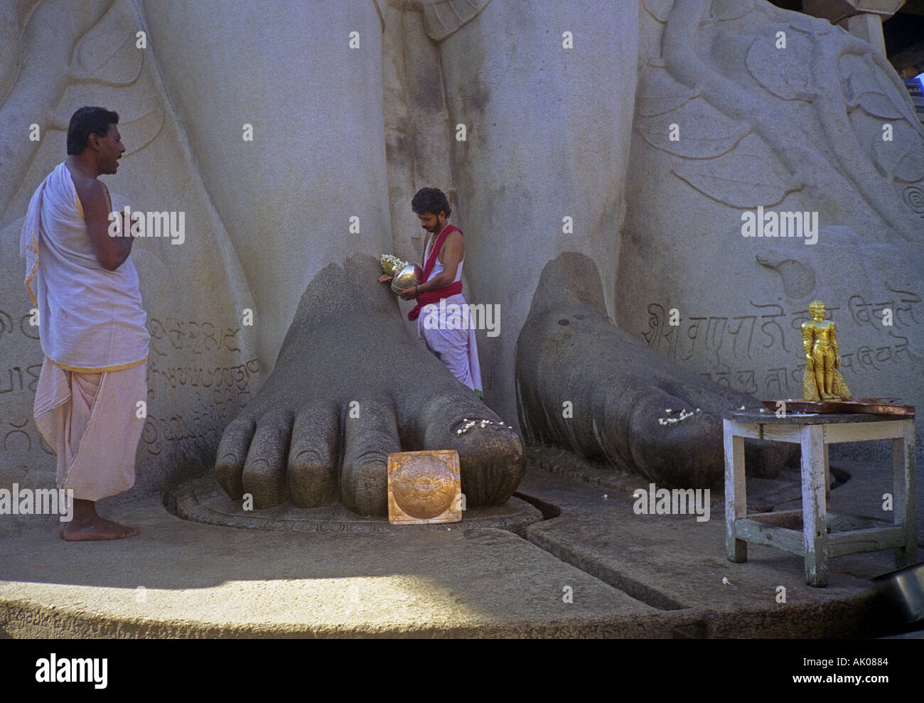 Hindu priest ceremony celebrate pray bless feet foot Gomatheswara ...
