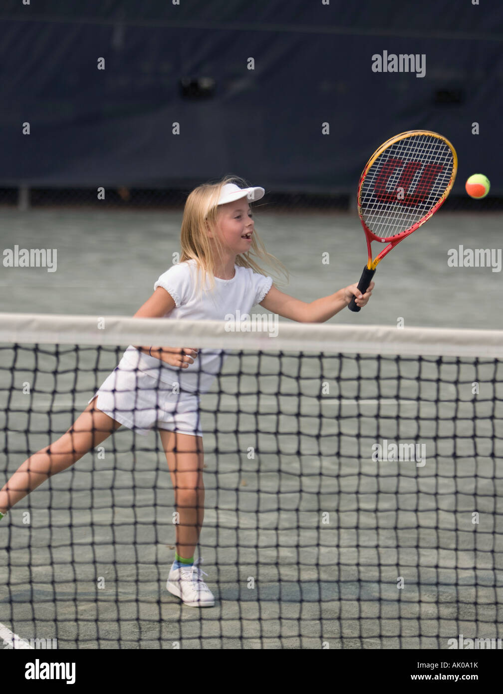 Girl hitting tennis ball racket hi-res stock photography and images - Alamy