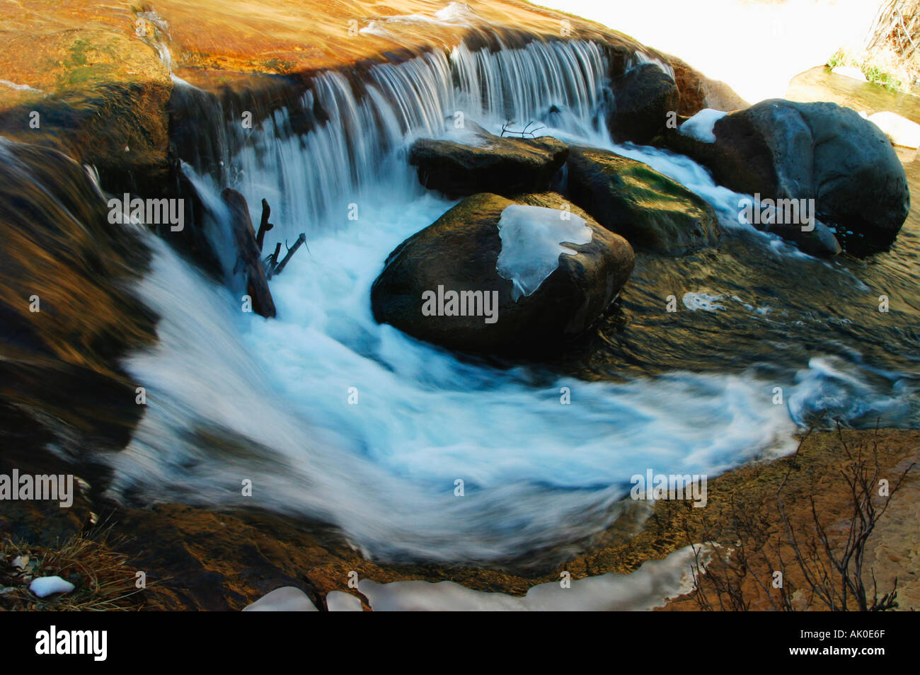 A small swirling waterfall greates the illusion of an impressionist ...