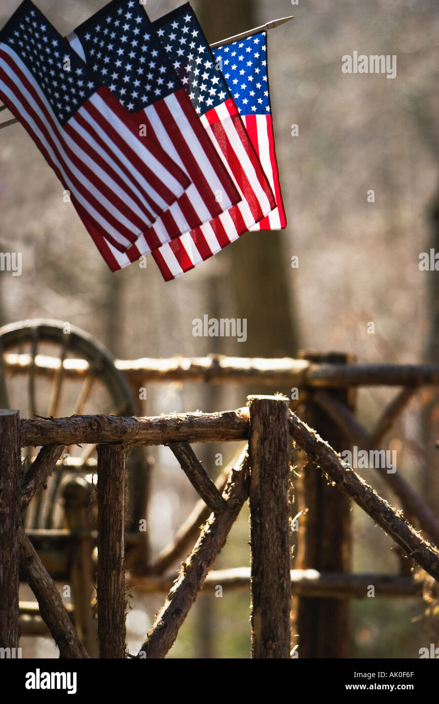 Adirondack cabin with rustic railing and backlit american flags Stock ...