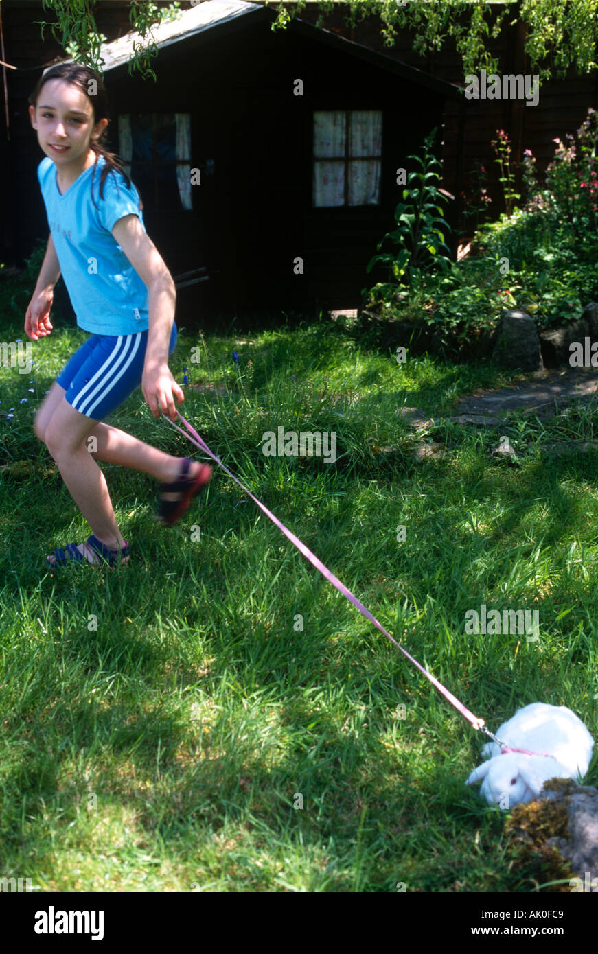 UK Child playing with rabbit in garden SB Stock Photo - Alamy