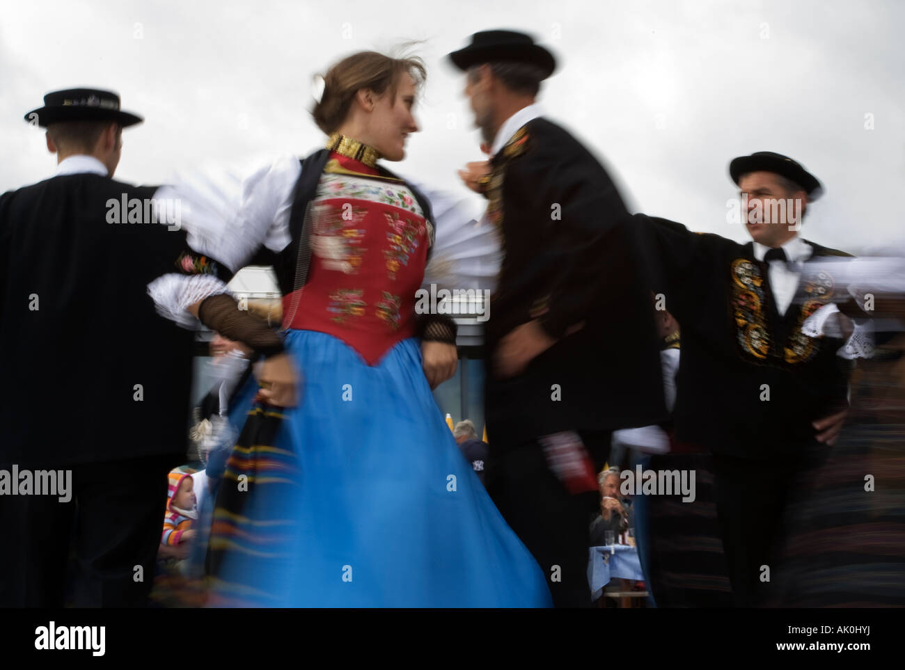 Man and woman performing traditional Swiss dancing in the mountains ...