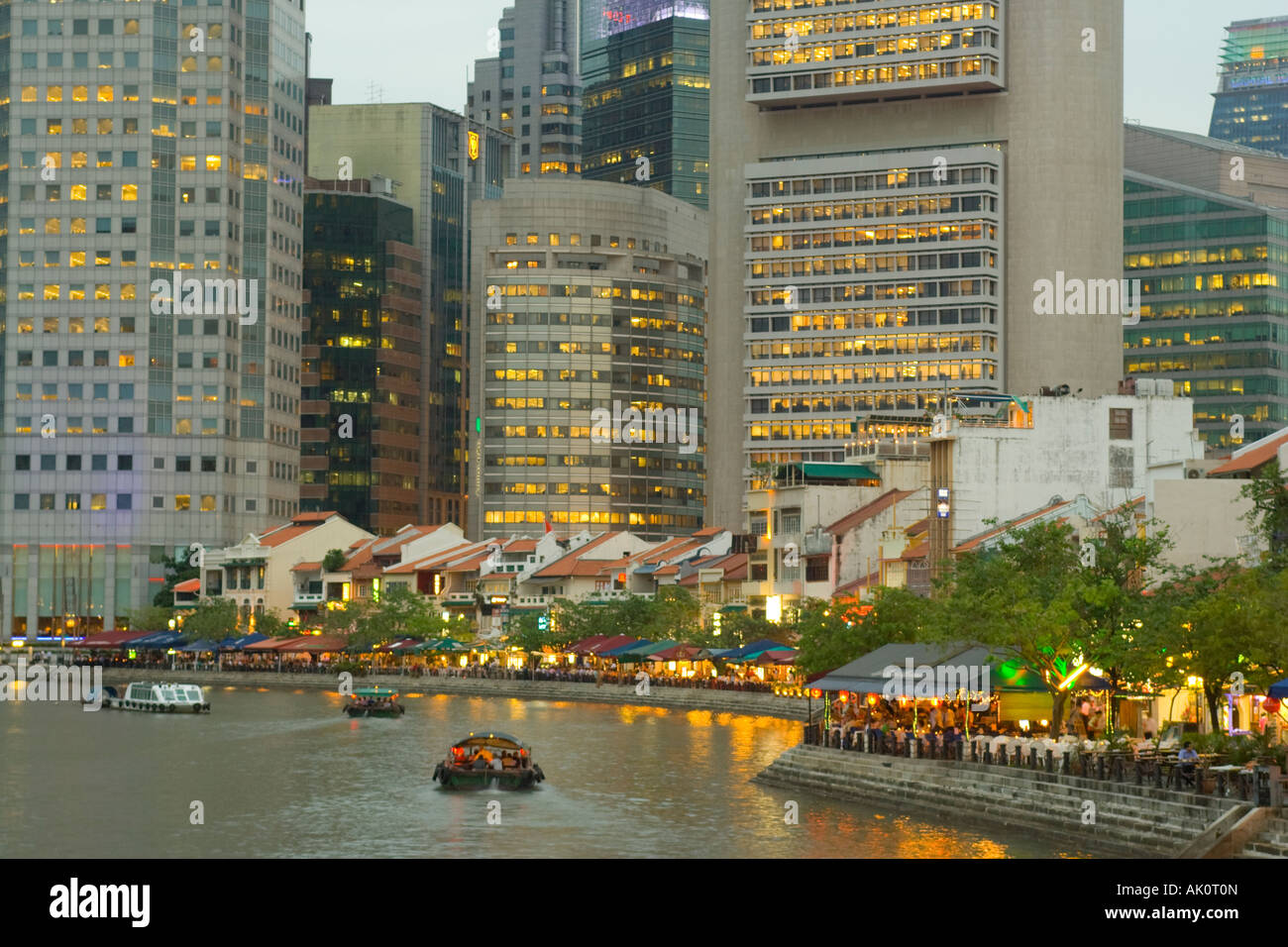 Dusk view of restored old buildings on Boat Quay along the Singapore ...