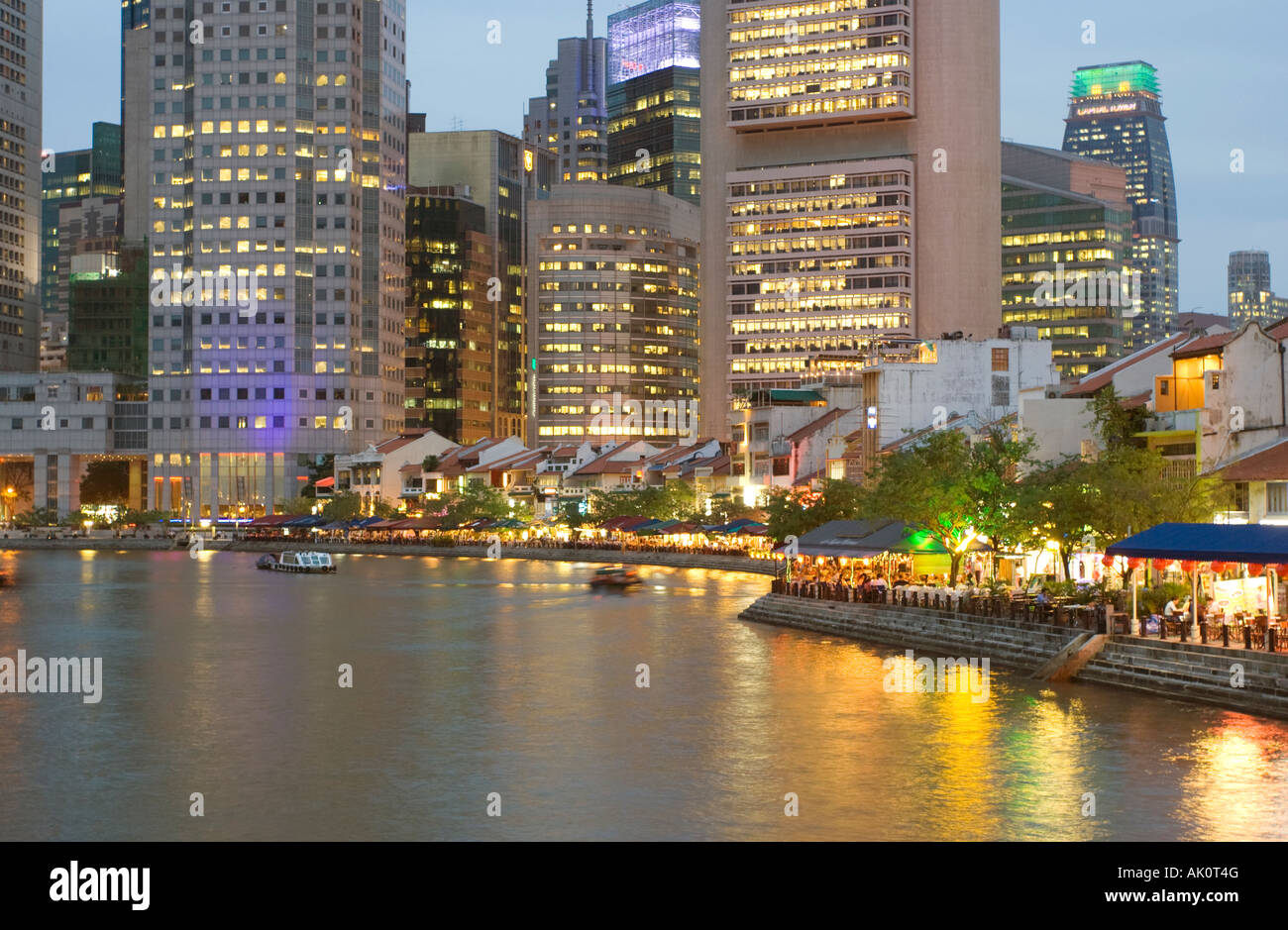 Dusk view of restored old buildings on Boat Quay along the Singapore ...