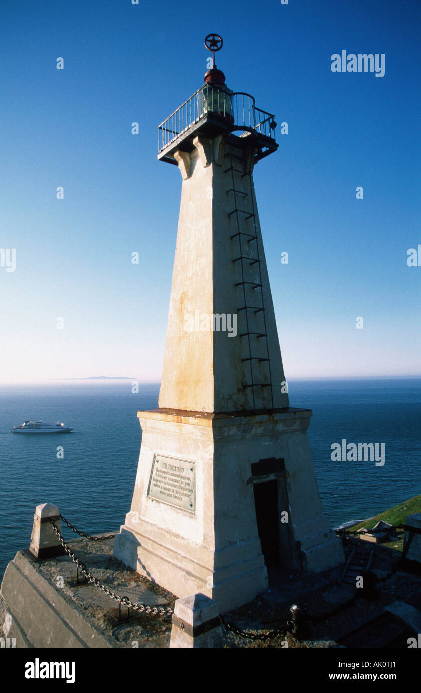 Lighthouse with monument Stock Photo - Alamy