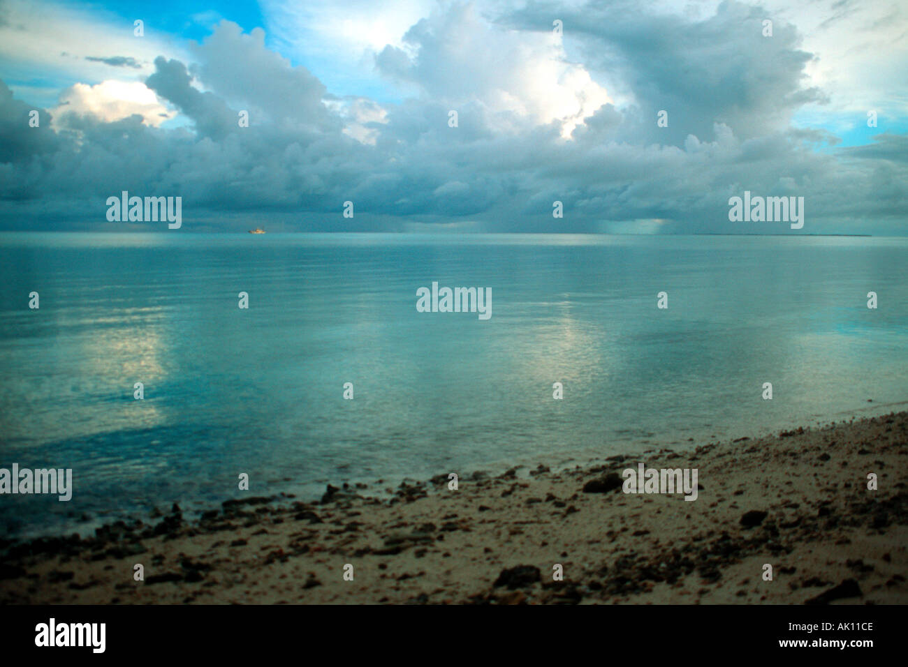 Triple rainstorm over lagoon Tokewa I Mili Marshall Islands N Pacific ...