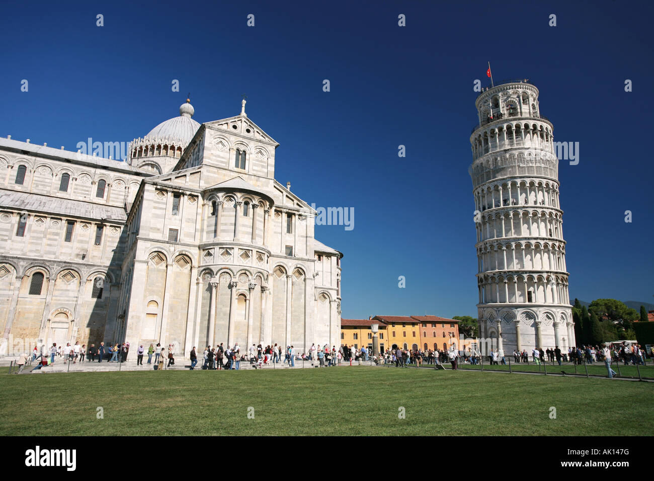 Tourists crowd Campo dei Miracoli visiting famous Leaning Tower of Pisa ...