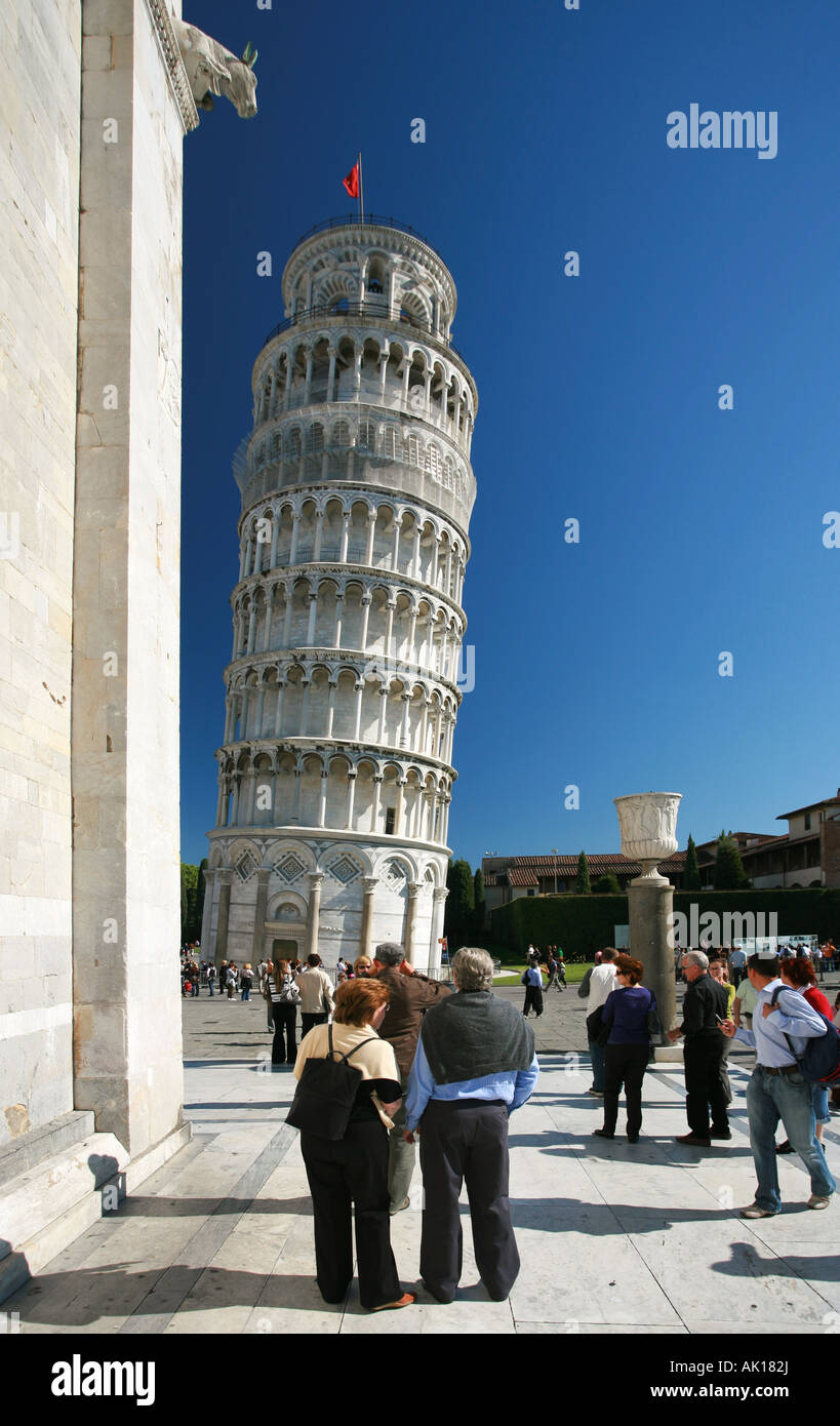Tourists visit famous leaning tower of Pisa with upright Duomo ...