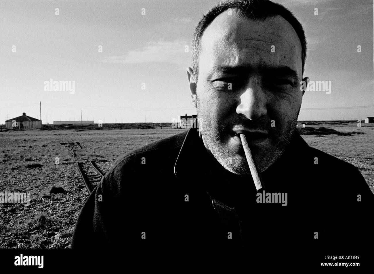 Man smoking cigar outside Kent coast England UK black and white Stock ...