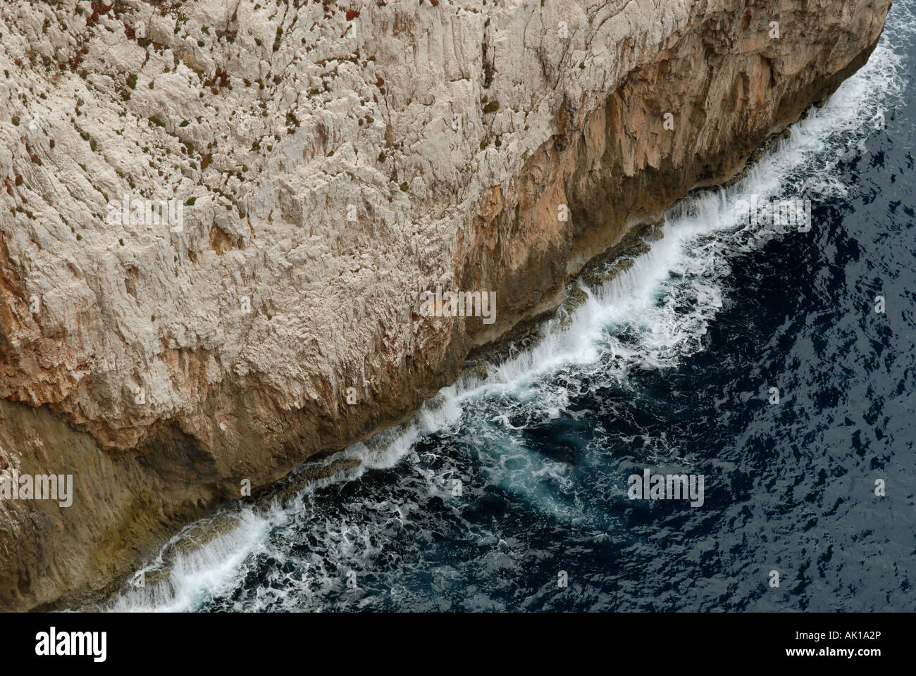 an aerial view of the sea crashing up against the cliff Stock Photo - Alamy