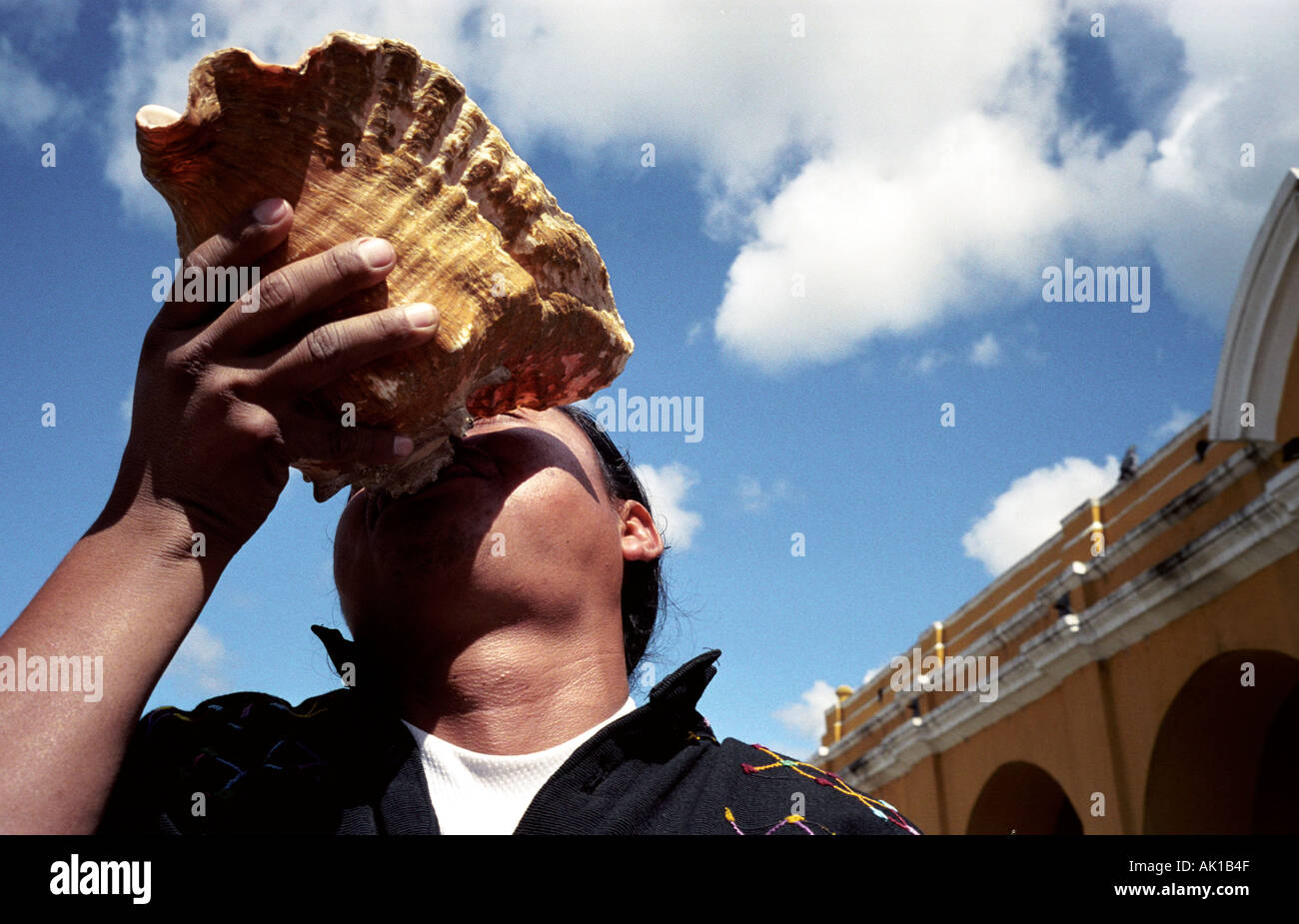 Man blowing conch shell hi-res stock photography and images - Alamy