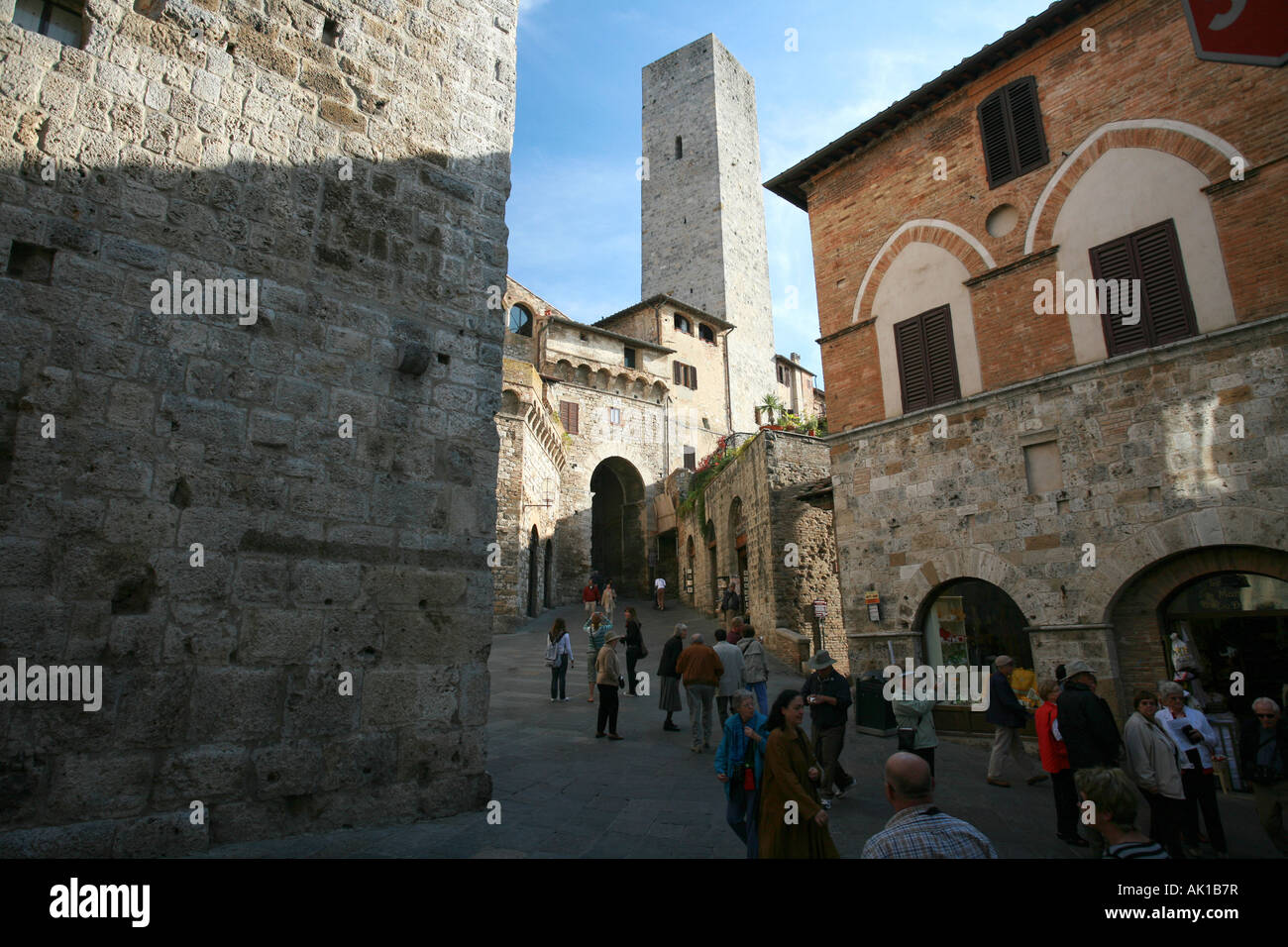 Tourists visit the ancient stone towers and buildings squares of ...