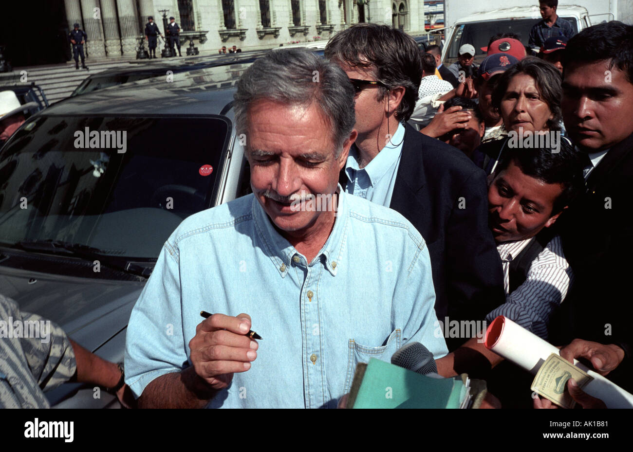 President Oscar Berger of Guatemala signing autographs in front of the ...