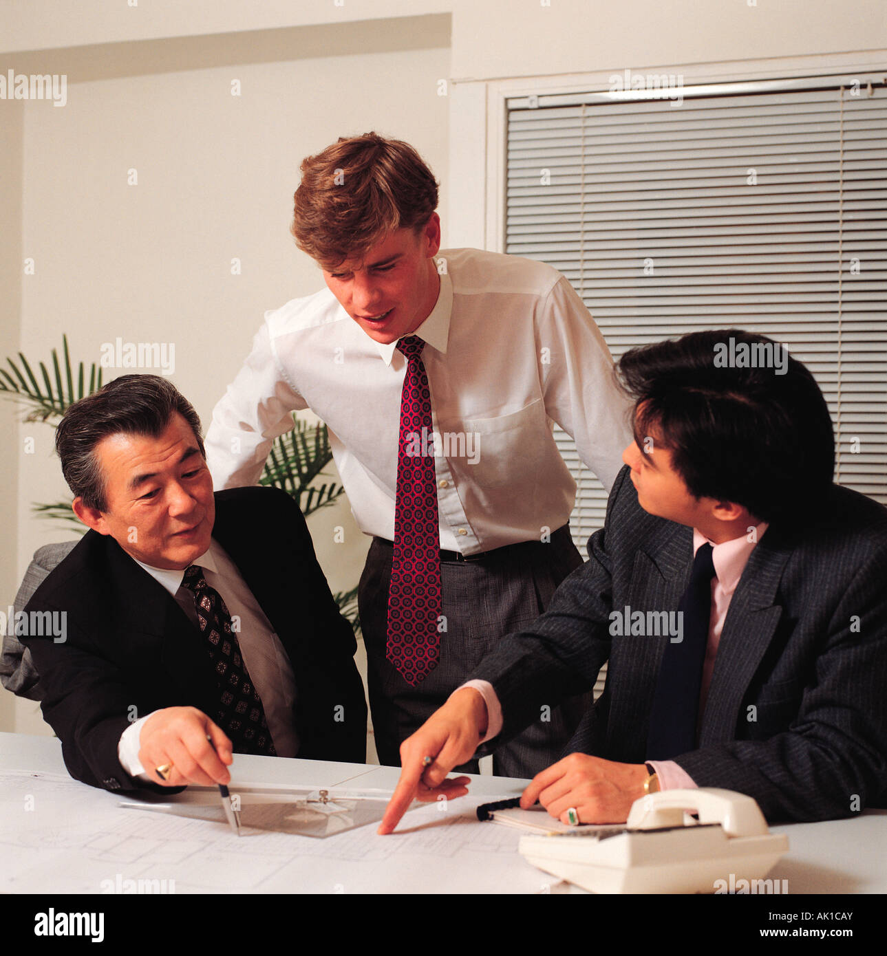 Business & professions. Three men meeting in office Stock Photo - Alamy