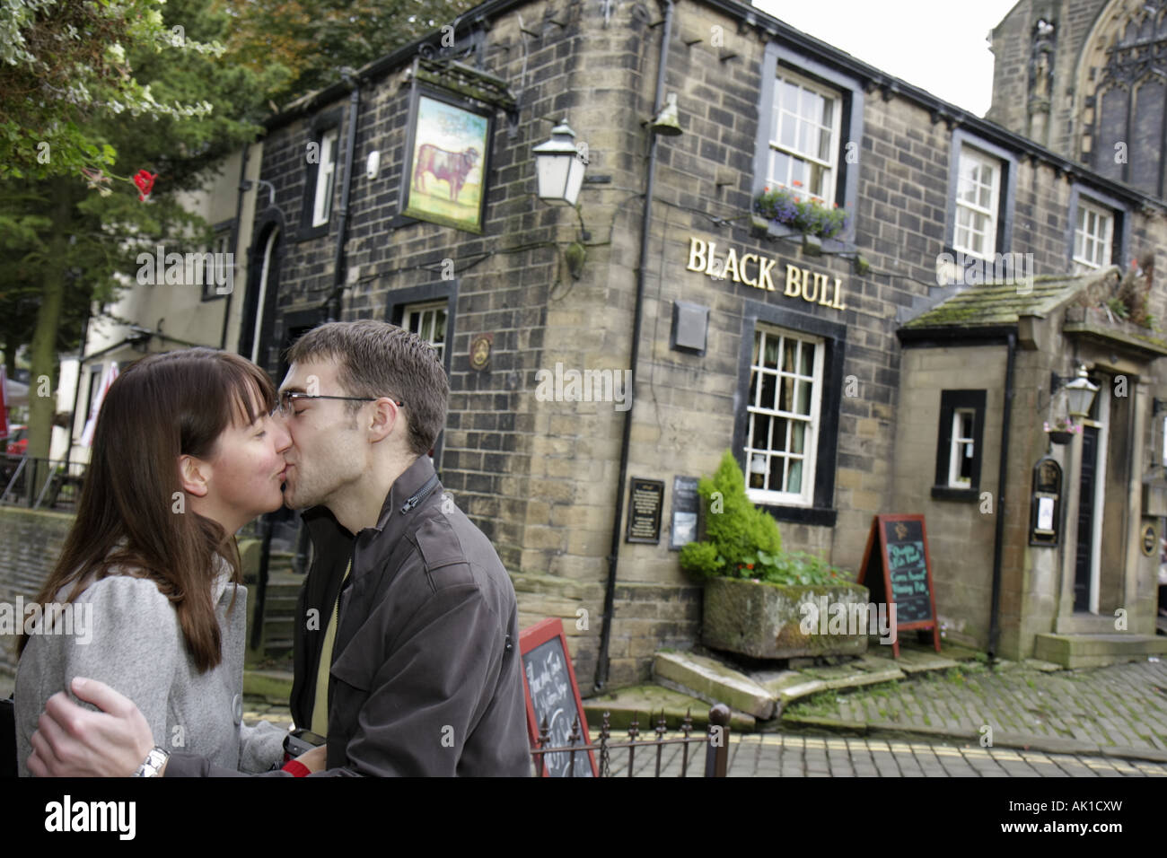 UK England North Yorkshire,Haworth,Main Street,romantic couple kissing ...